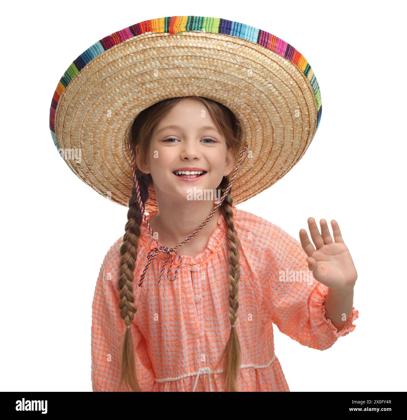 Cute girl in Mexican sombrero hat waving hello on white background ...