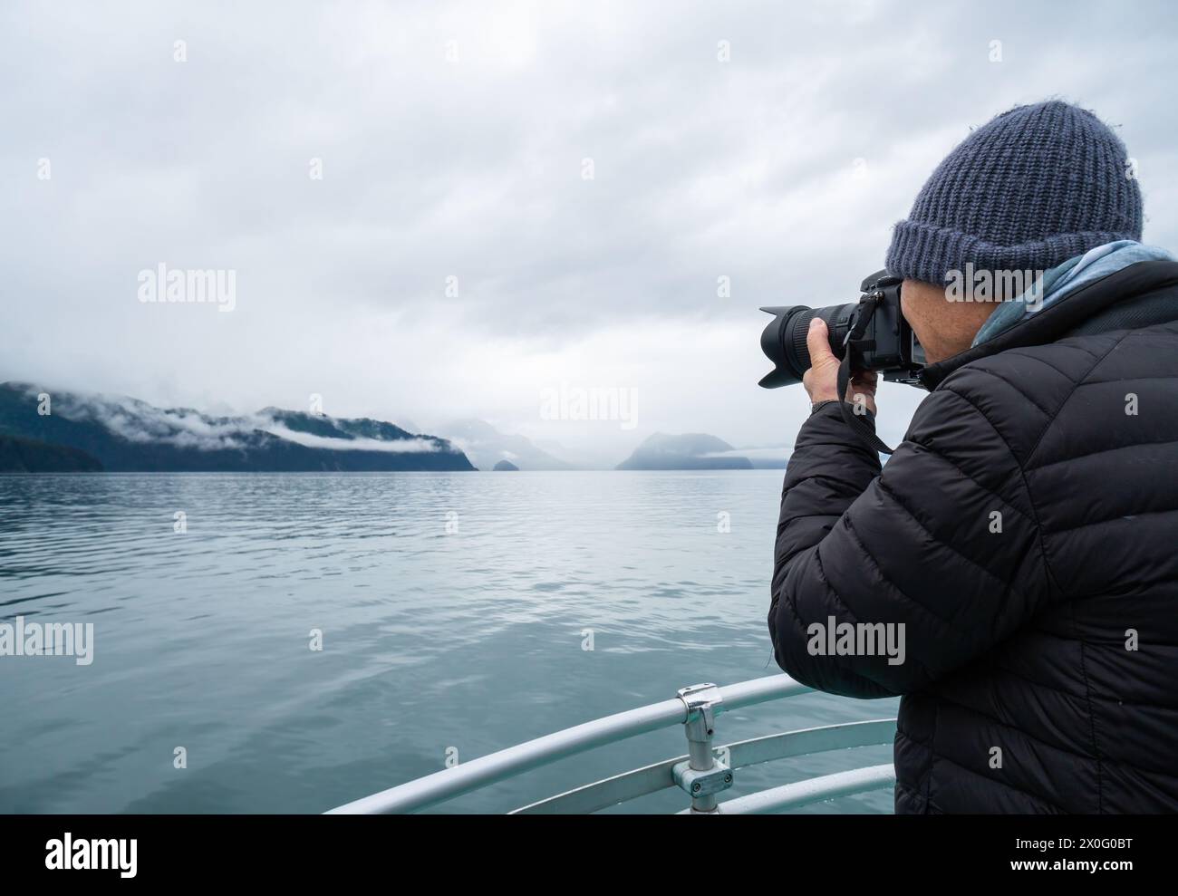 Tourist taking photos using a DSLR camera. Boat cruising Resurrection ...