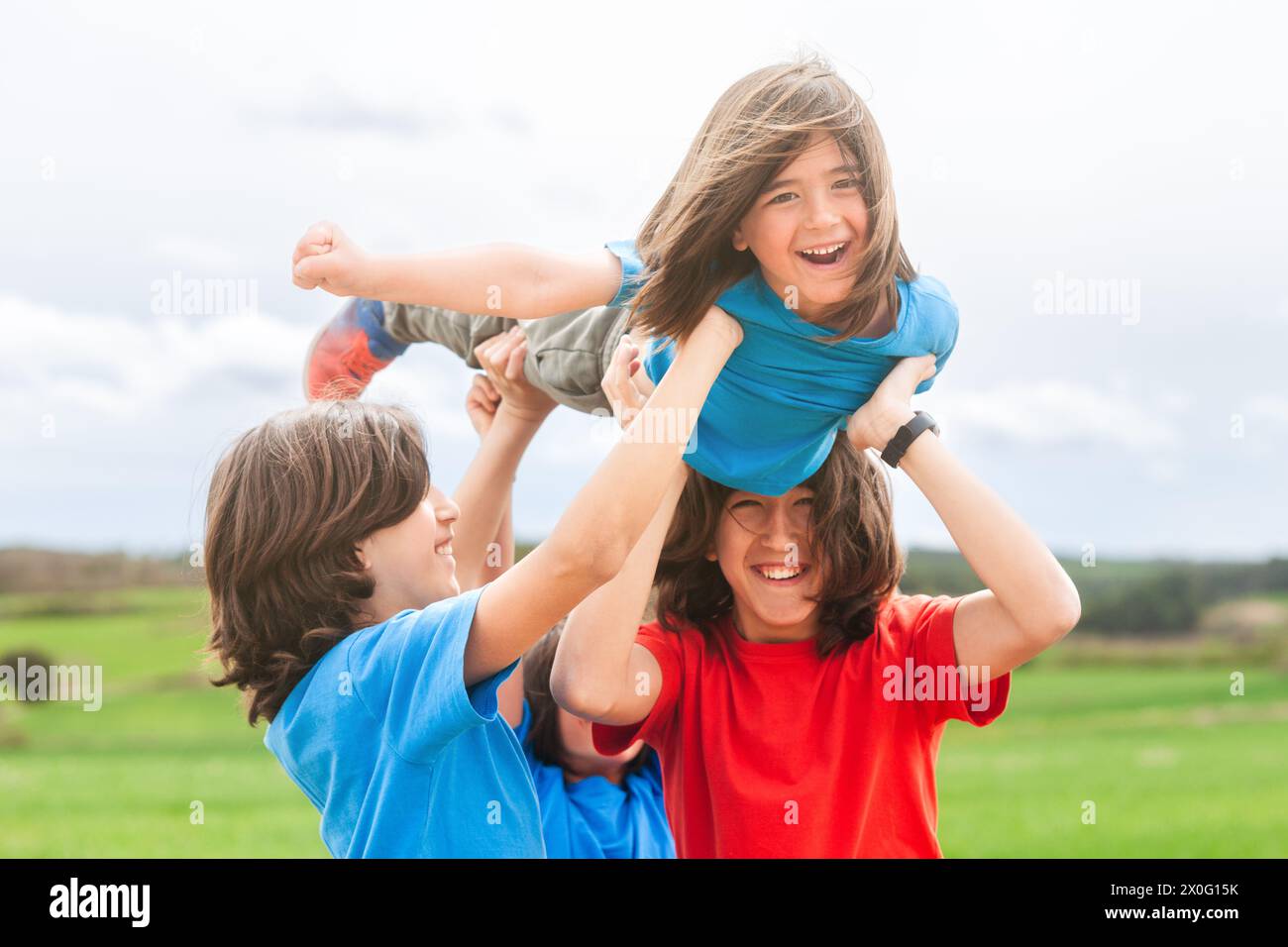 A group of brothers grab the youngest of them all and lift him above ...