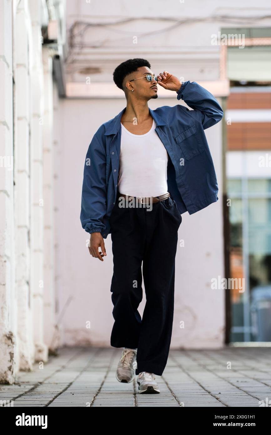 Fashionable man walking outside hi-res stock photography and images - Alamy