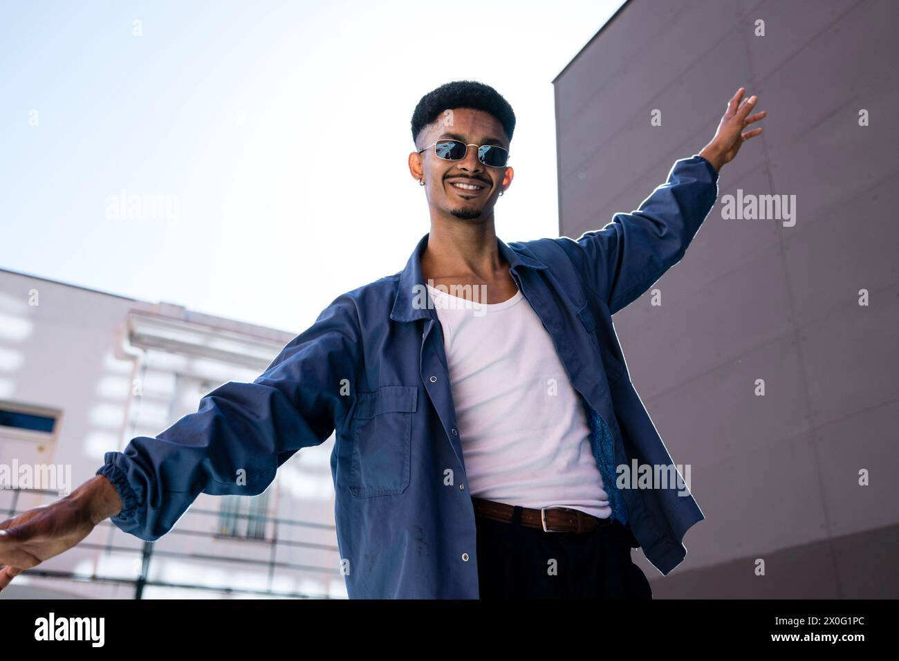 Handsome stylish happy man extended hands and arms outside Stock Photo ...