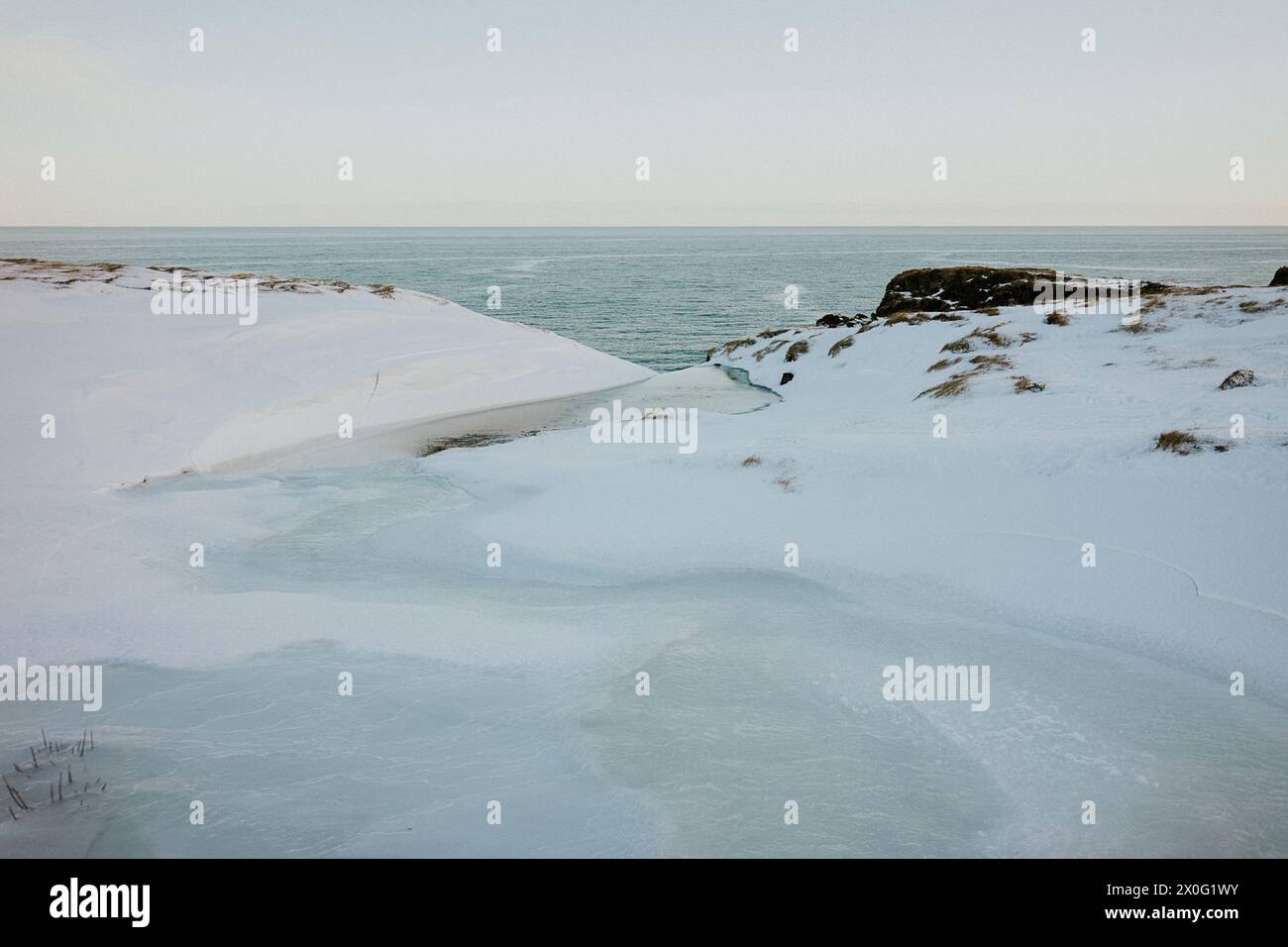 Frozen river flowing into the Atlantic Ocean in Anarstapi Iceland Stock ...