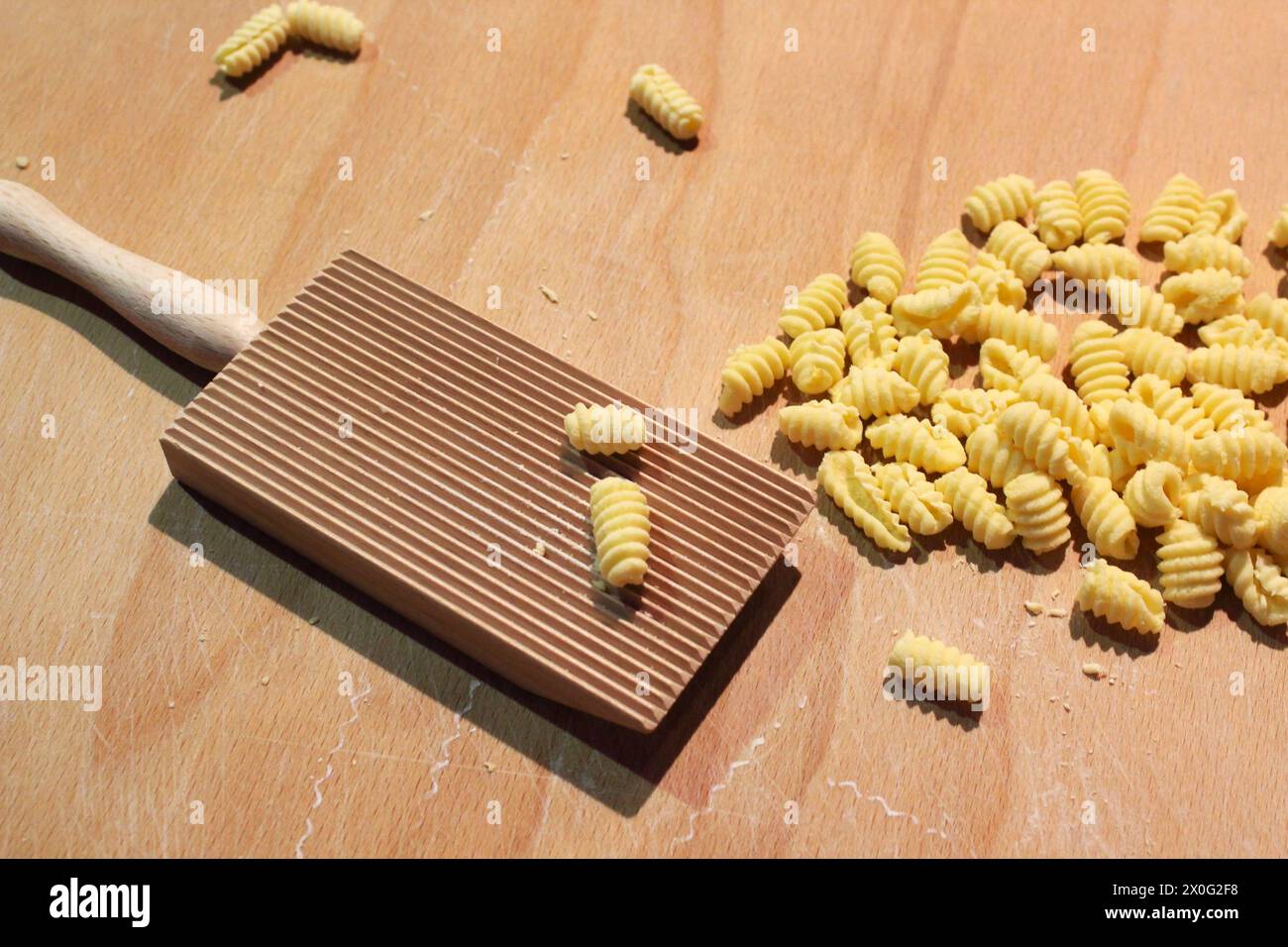 Freshly made pasta on a butcher block counter Stock Photo - Alamy