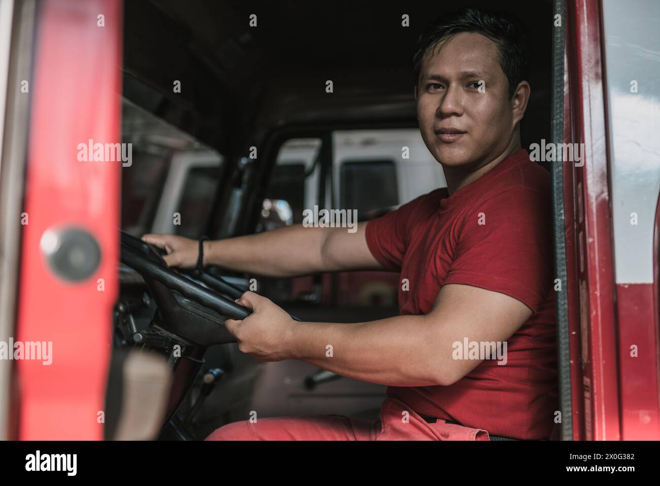 Portrait of fire truck driver smiling at fire station Stock Photo - Alamy