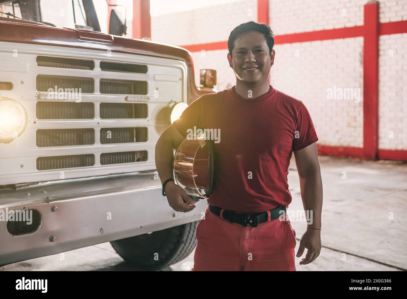 Portrait of latin fireman standing at fire station Stock Photo - Alamy