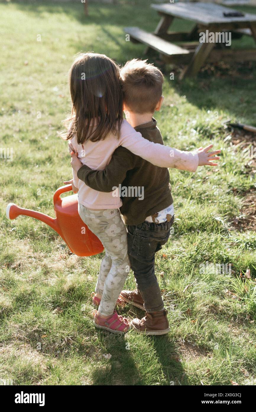 Boy and girl children working in garden hi-res stock photography and ...
