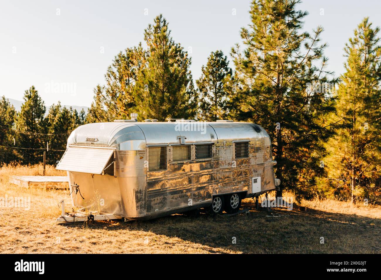 Aluminum trailer parked on grass in sunlight Stock Photo - Alamy
