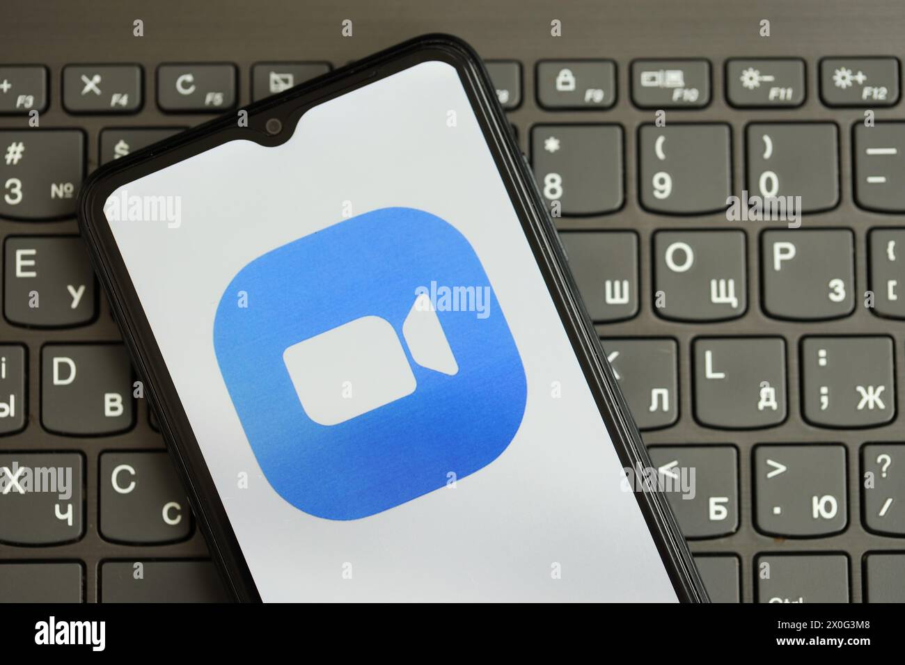 KYIV, UKRAINE - APRIL 1, 2024 Zoom icon on smartphone screen on black ...