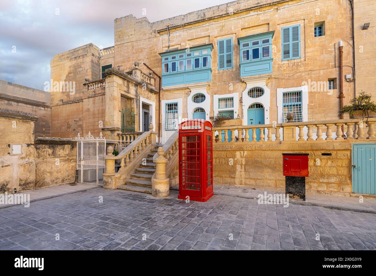Valletta, Malta, April 03, 2024. The typical phone booth and old houses ...