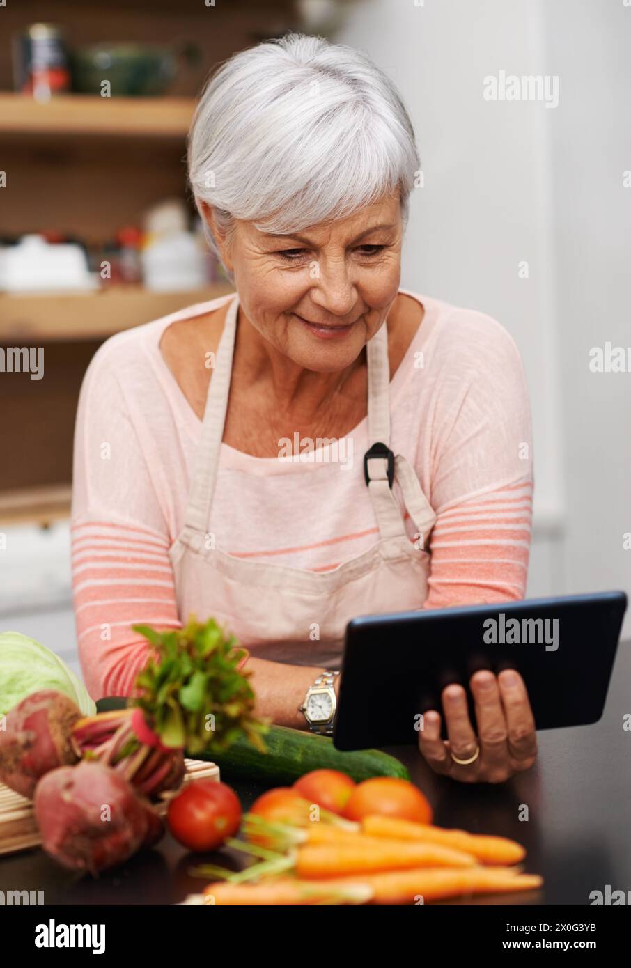 Senior woman, tablet and vegetables for cooking wholesome, healthy and ...