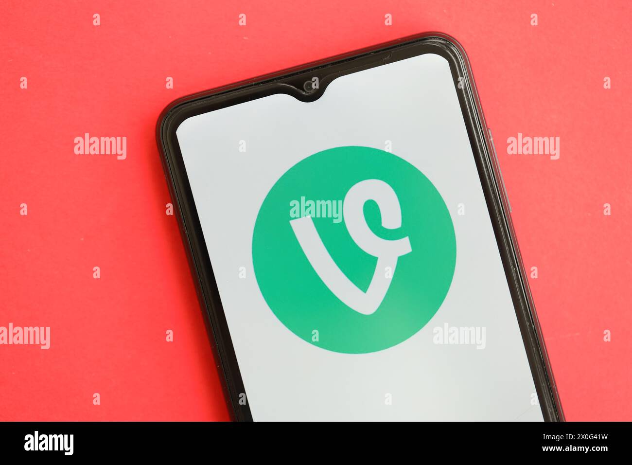 KYIV, UKRAINE - APRIL 1, 2024 Vine icon on smartphone screen on red table close up. iPhone ...