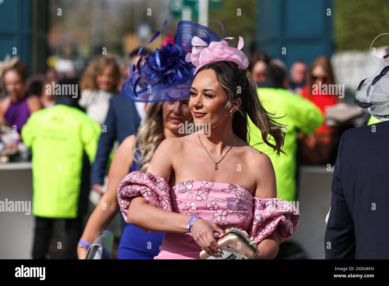 Racegoers arrive on ladies day at during the The Randox Grand National ...
