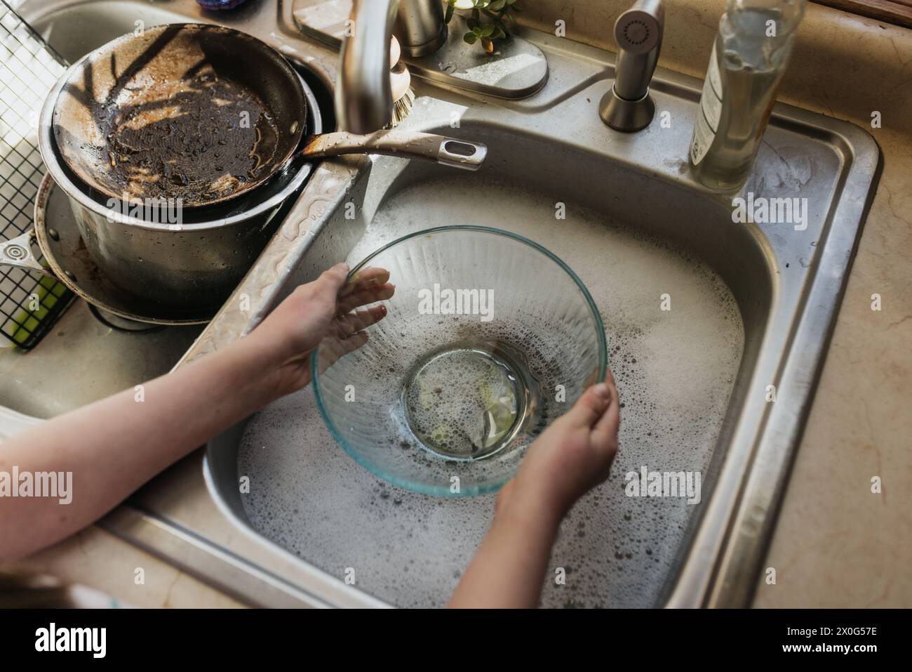 Above shot of young girl washing dishes in kitchen sink Stock Photo - Alamy