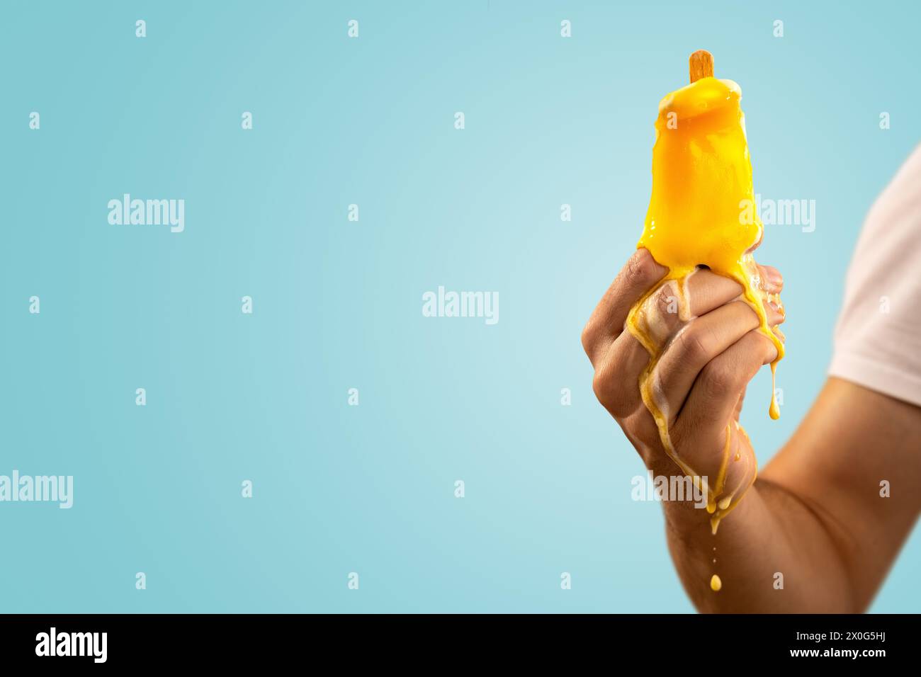 Melting Ice Pop Held by a Hand with Copy Space Stock Photo - Alamy