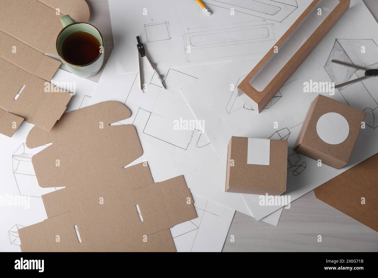 Creating packaging design. Drawings, boxes, coffee and stationery on ...