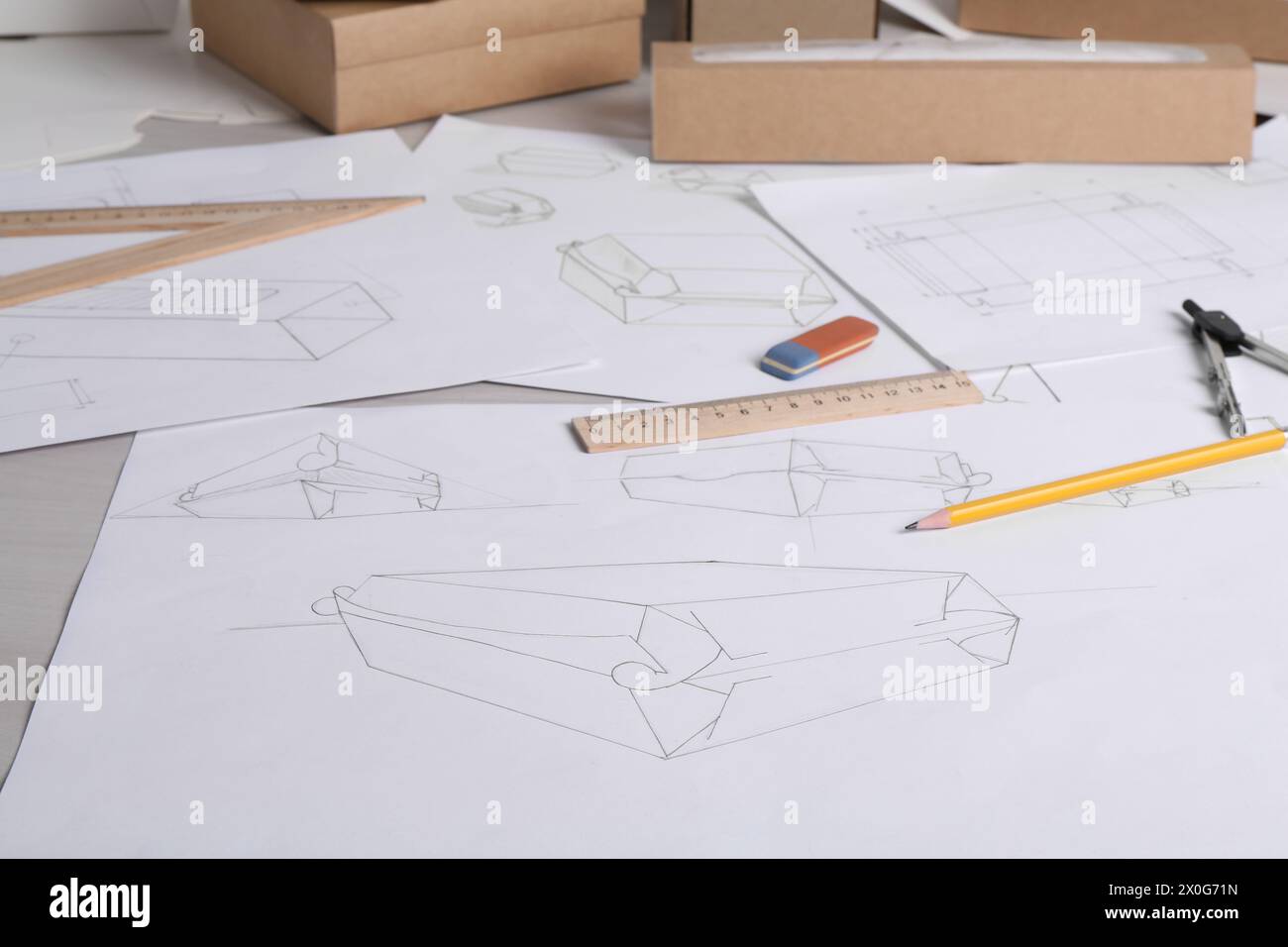 Creating packaging design. Drawings, boxes and stationery on light ...