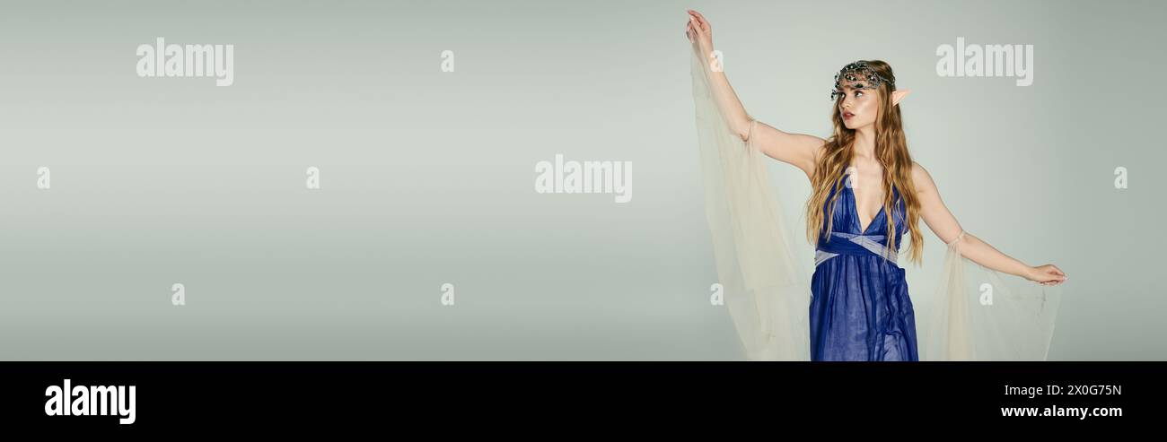 A young woman, resembling an elf princess, stands wearing a blue dress ...