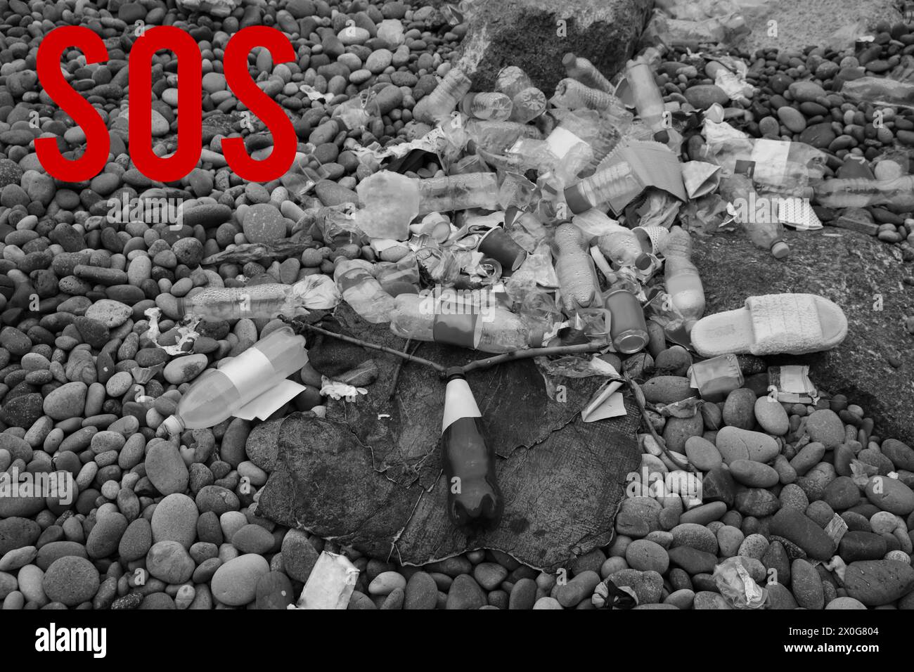 Word SOS and garbage scattered on pebbles outdoors. Recycling problem ...