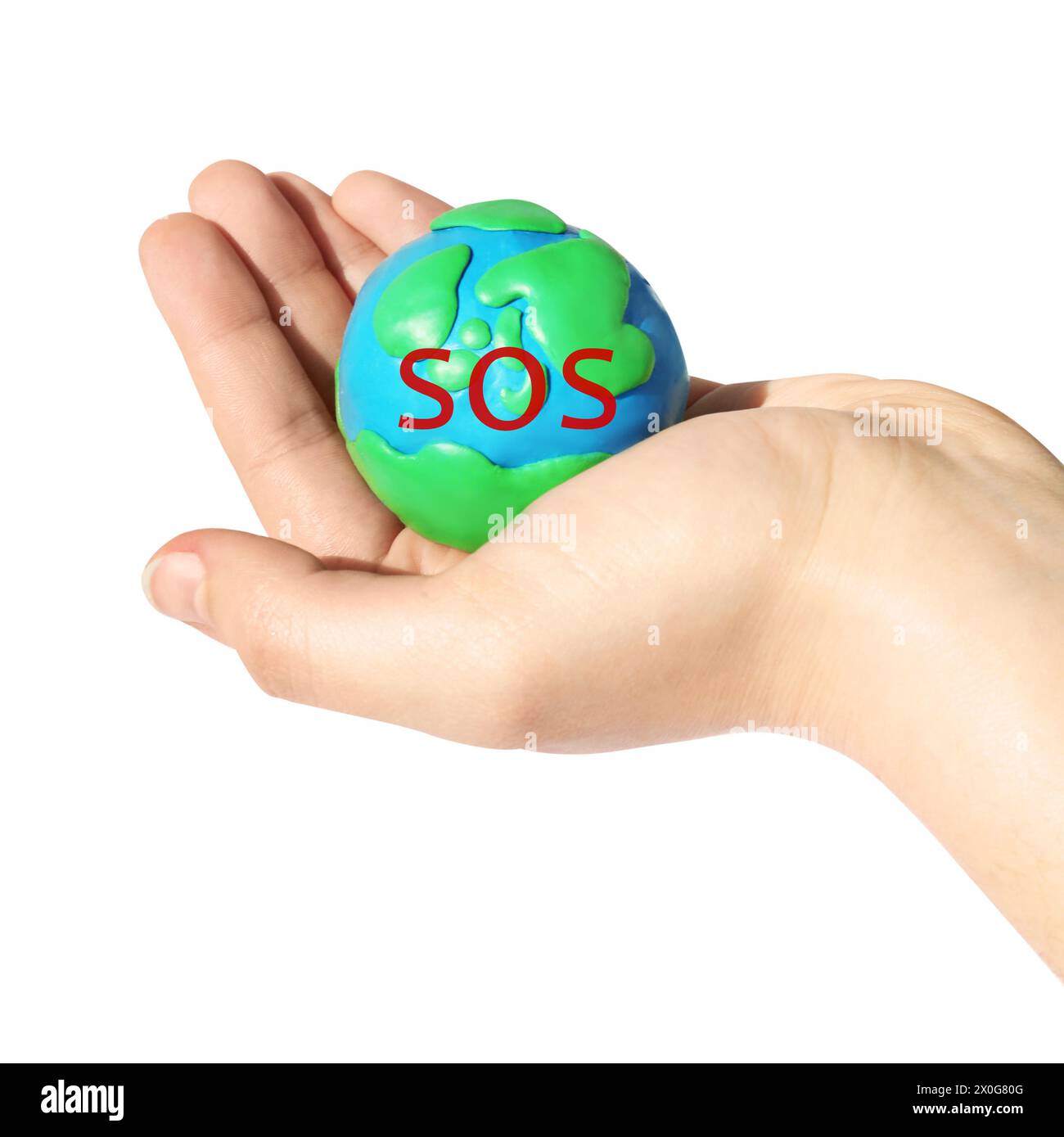 Woman holding plasticine model of planet Earth with word SOS on white ...