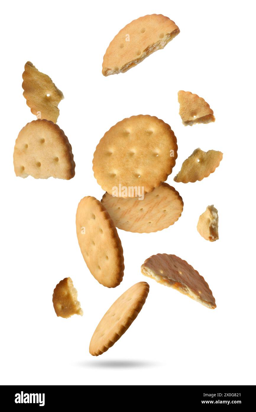 Tasty dry crackers falling on white background Stock Photo - Alamy