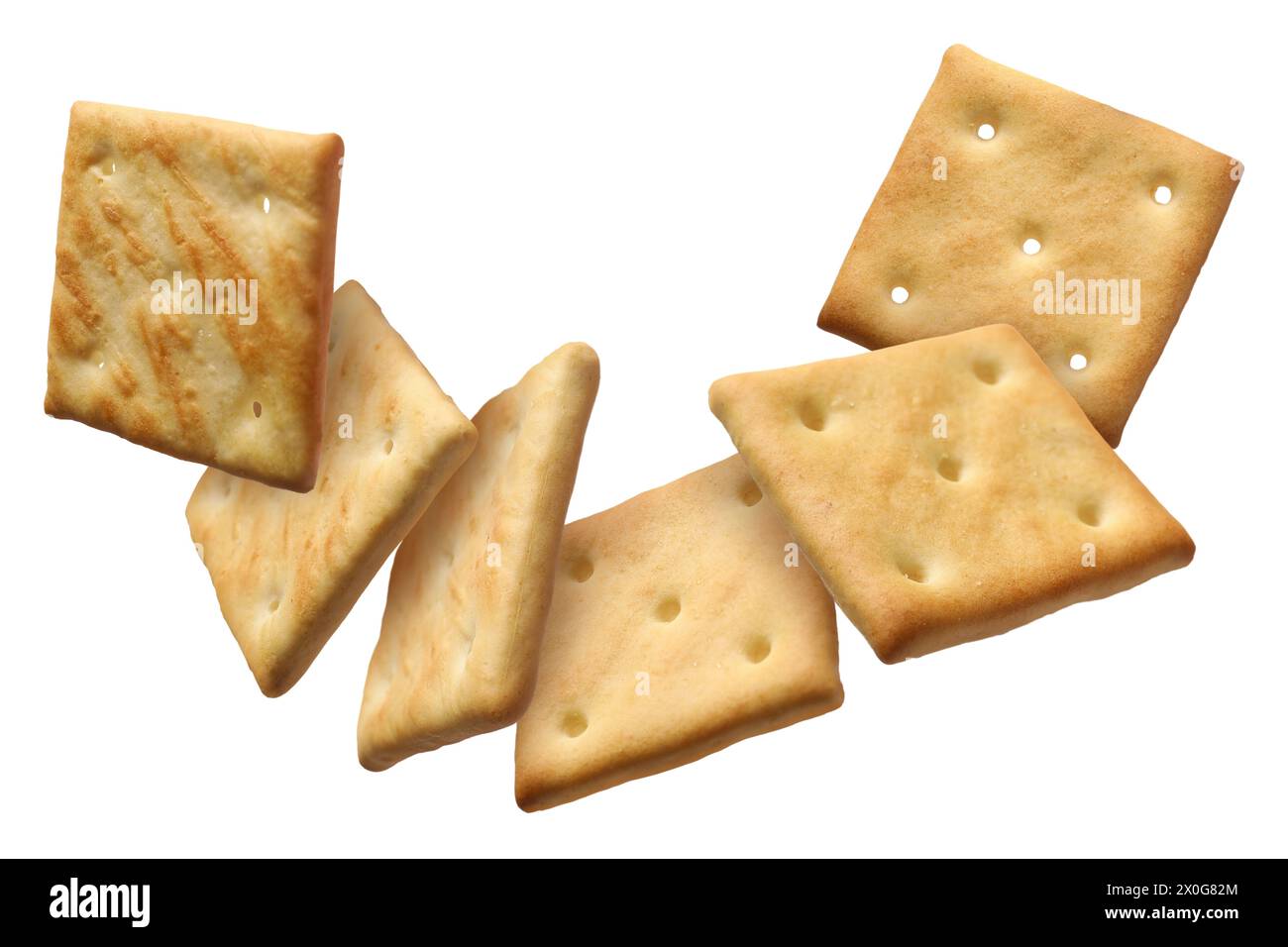 Tasty dry square crackers flying on white background Stock Photo - Alamy