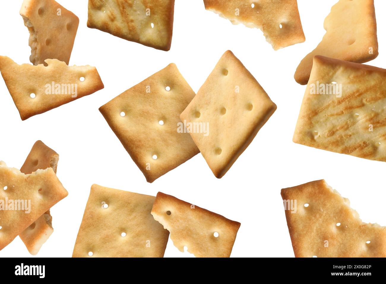 Tasty dry crackers falling on white background Stock Photo - Alamy