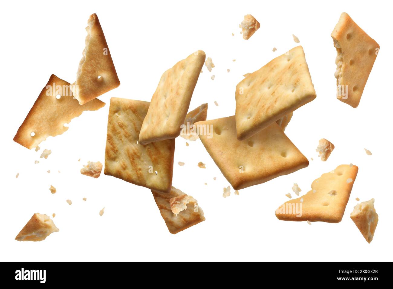 Tasty dry crackers falling on white background Stock Photo - Alamy