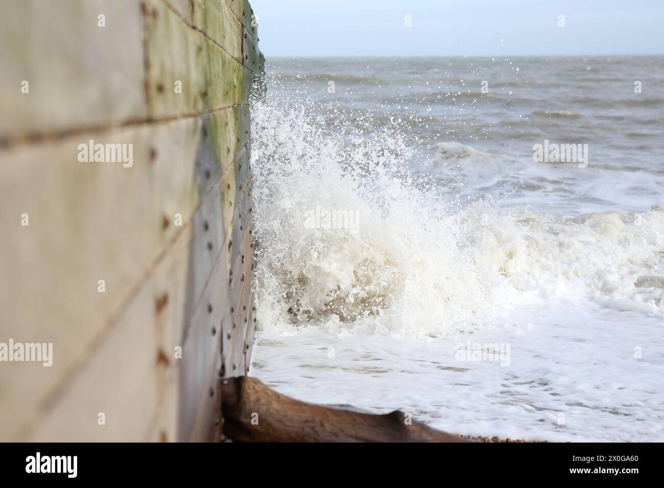 Wooden breakwater or groyne with waves from English Channel breaking ...