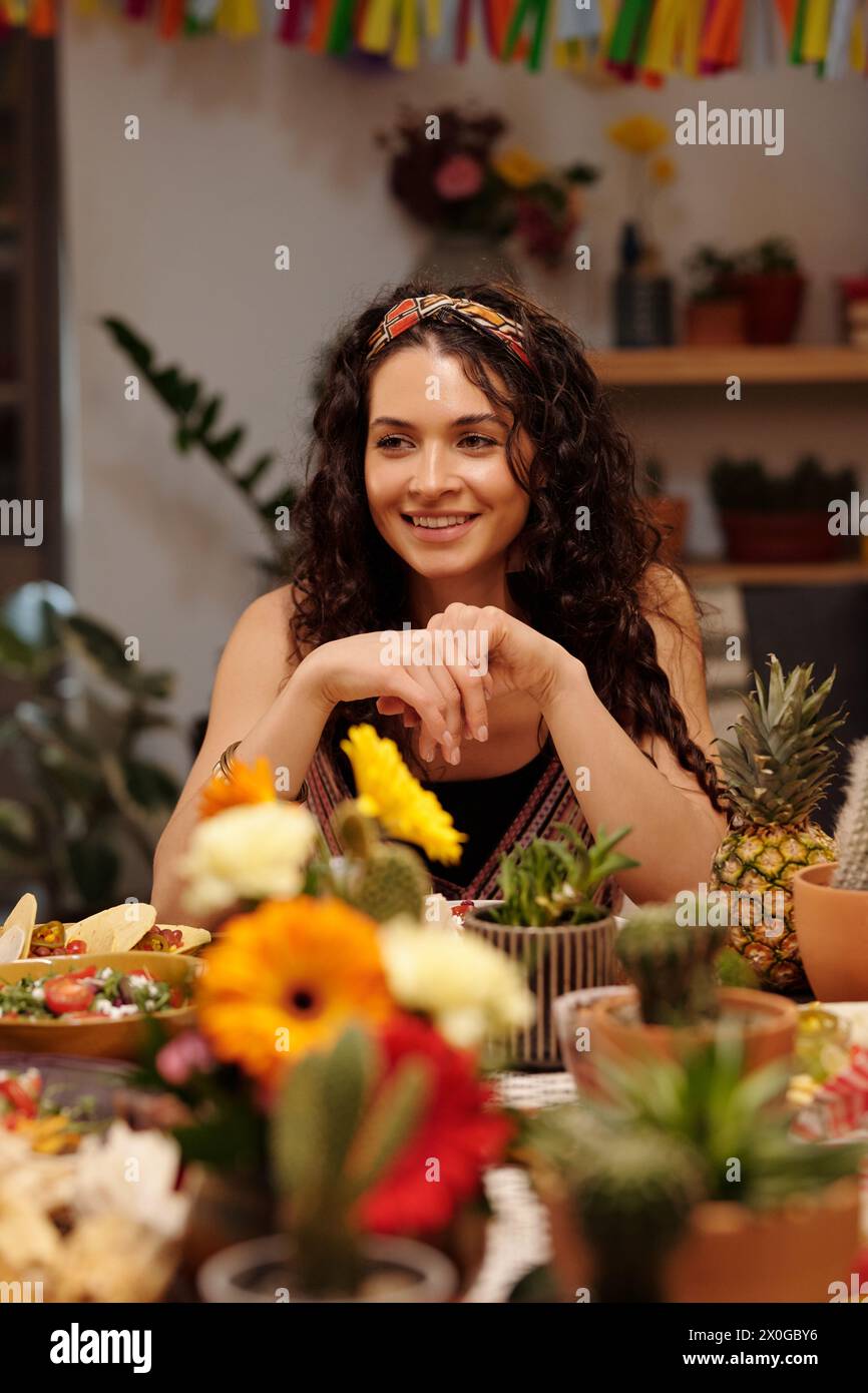 Young smiling brunette woman with headscarf in her long wavy hair ...