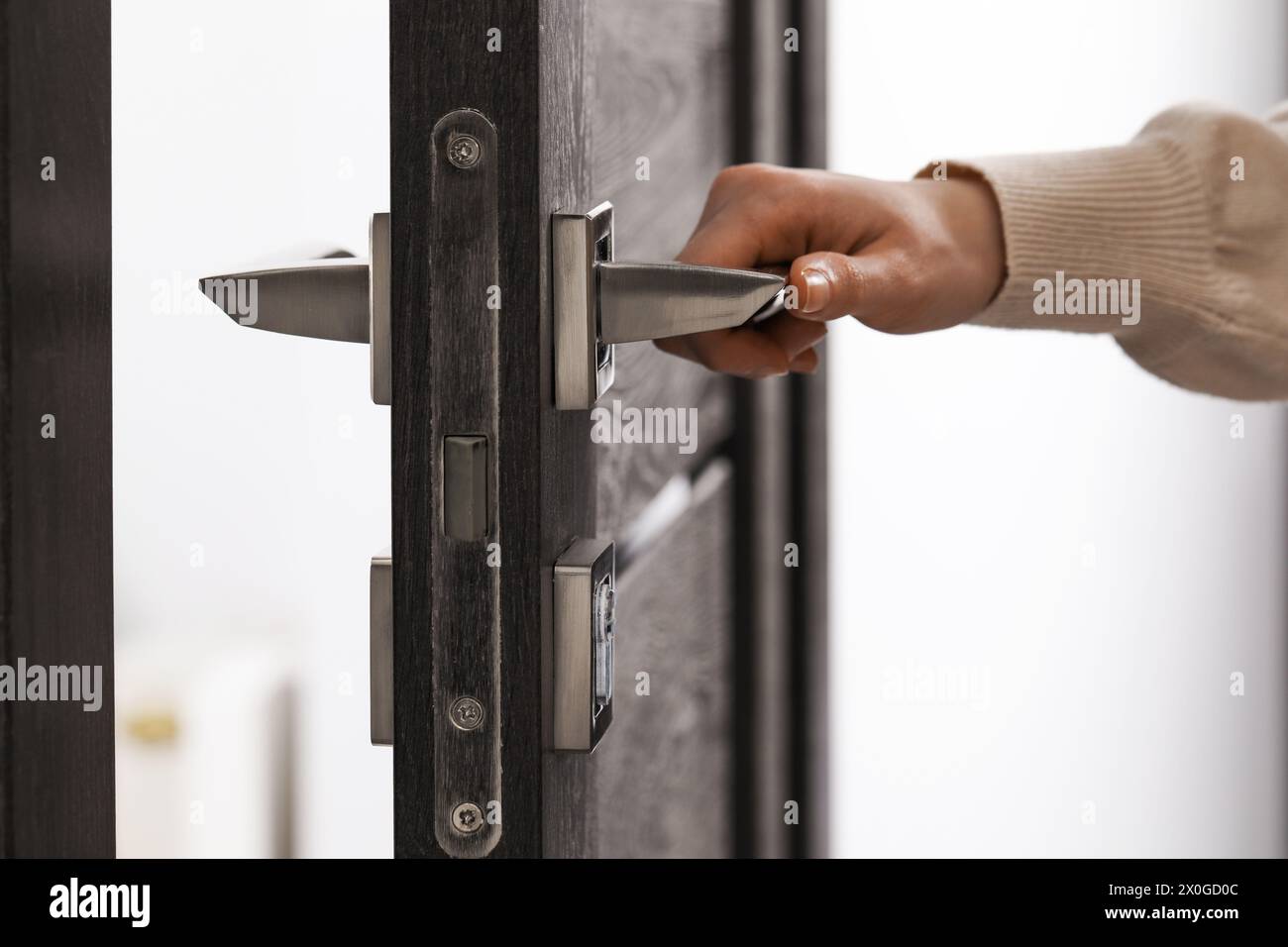 Hand on door handle woman hi-res stock photography and images - Alamy