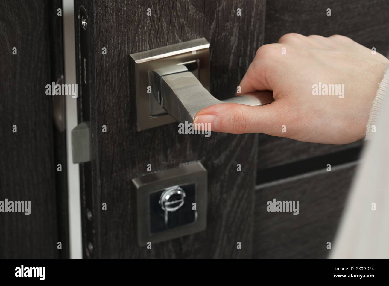 Hand on door handle woman hi-res stock photography and images - Alamy