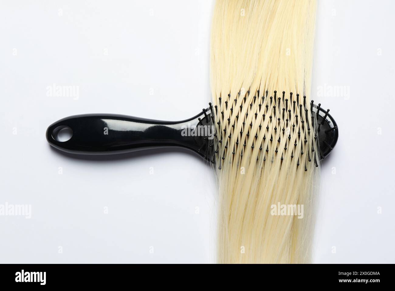Stylish brush with blonde hair strand on white background, top view ...