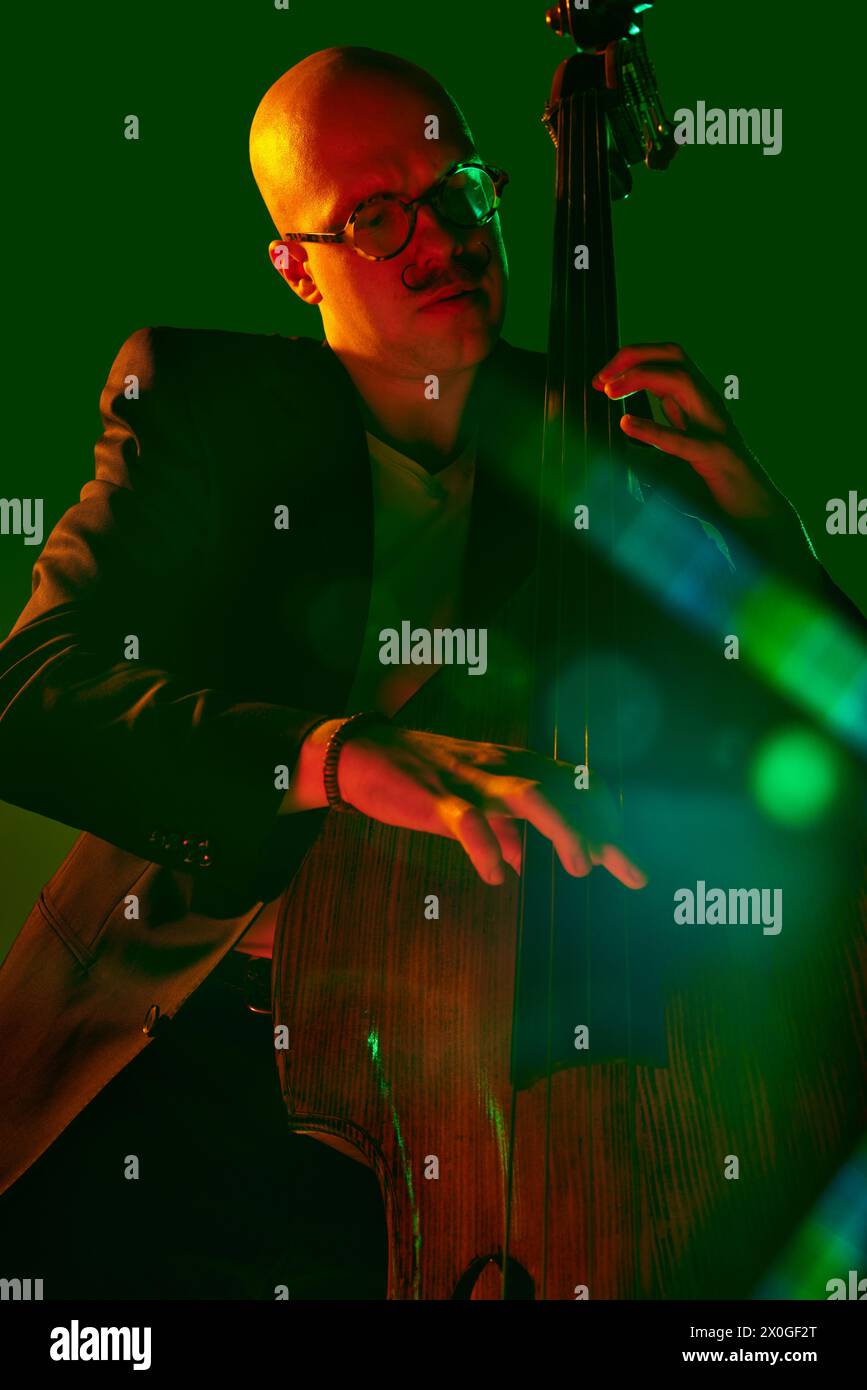 Bald man, talented cellist performing jazz compositions in red-green ...