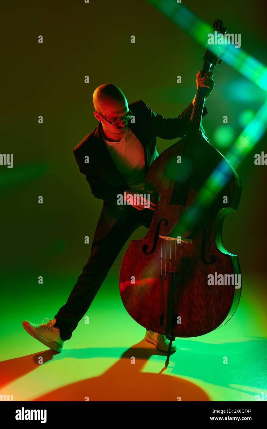 Talented cellist performing jazz compositions in red-green neon light ...