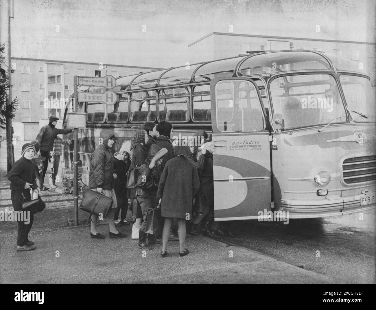 People get on a bus at the bus stop in Fürstenfeldbruck near Munich ...