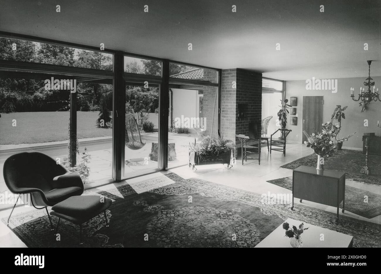 View from the large living room of a bungalow through the glazed front ...