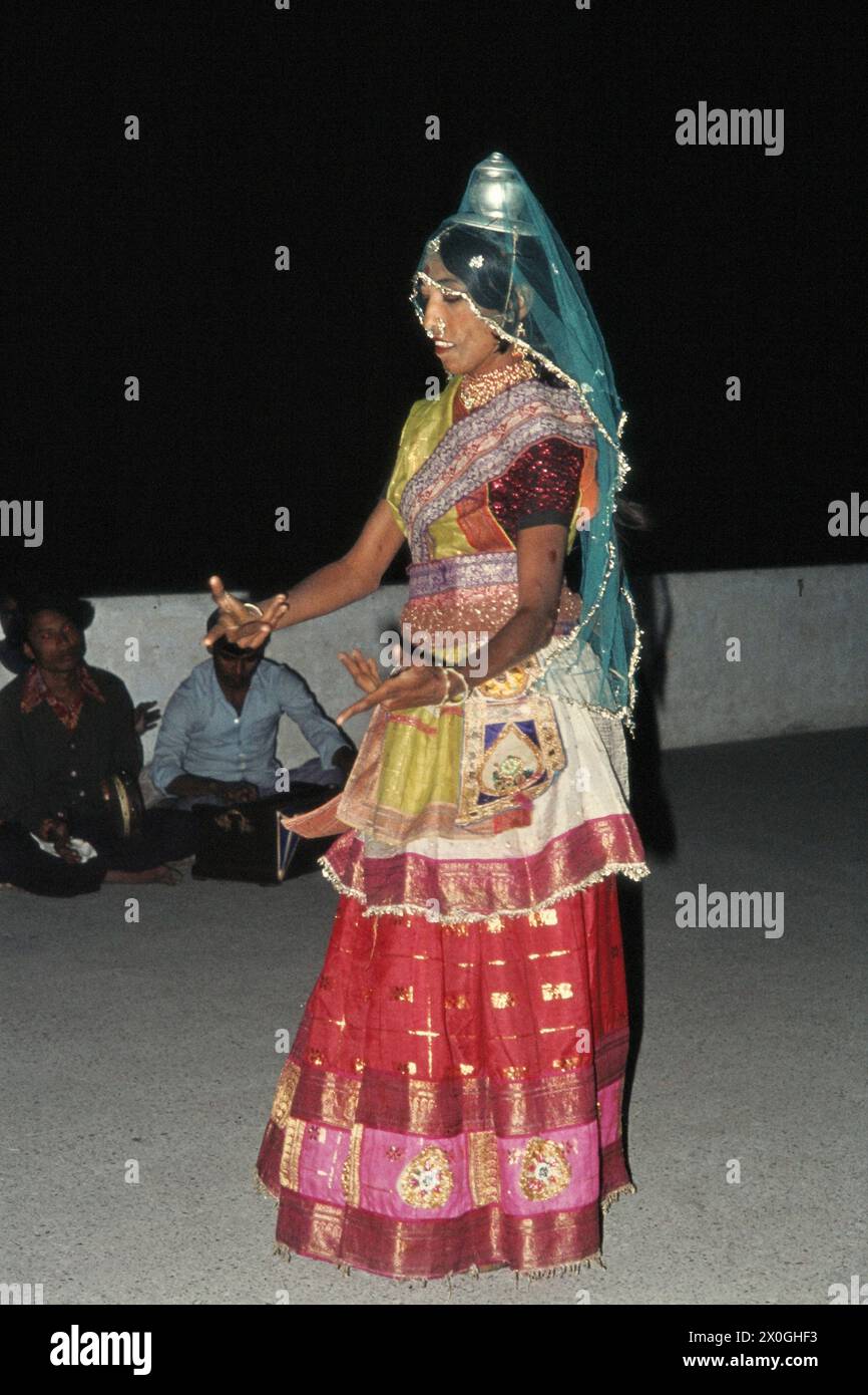 A woman with a veil and colorful sari performs the Old Temple Dance ...