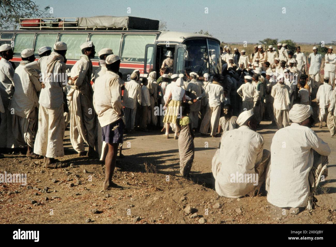 Locals stand around a bus in Manmad and are waiting to get on Stock ...