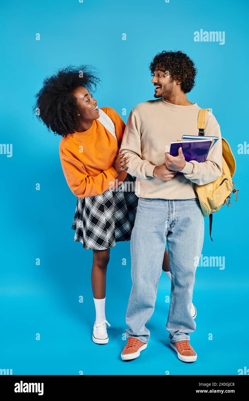 A couple of interracial students standing together in casual attire on ...