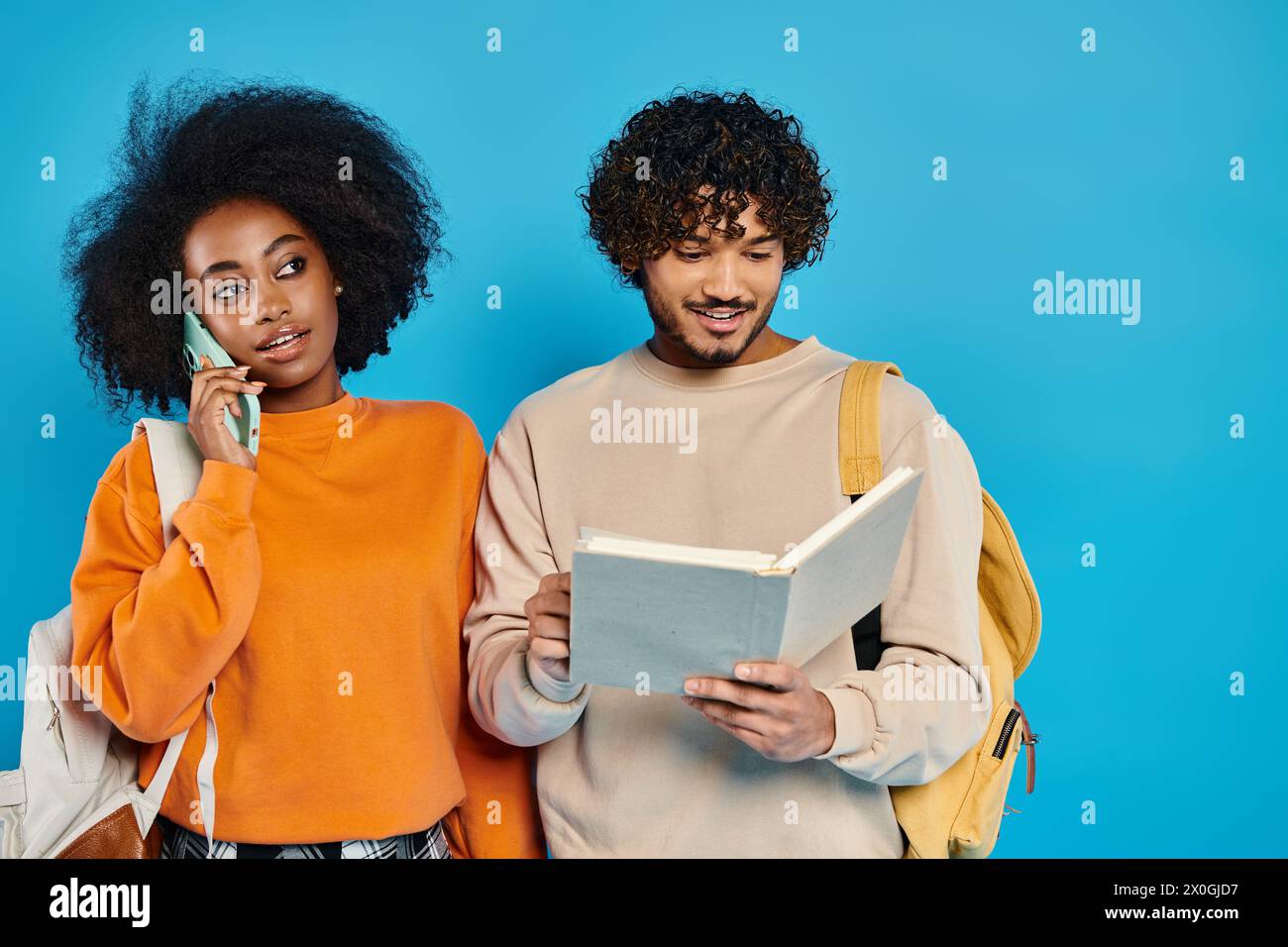 A man and a woman of different races standing together in a studio ...