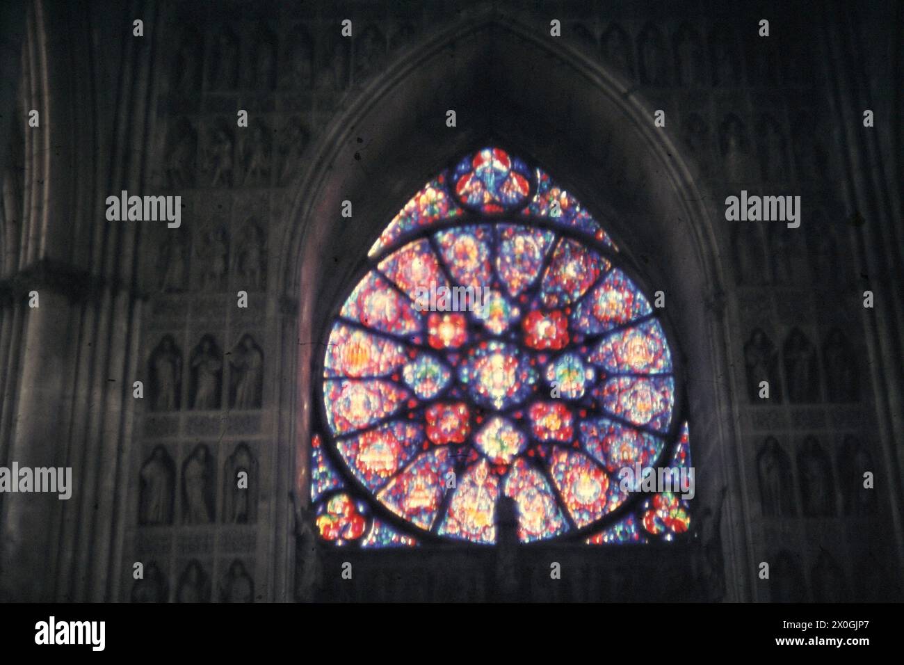 A stained-glass window in Reims Cathedral surrounded by figures built ...