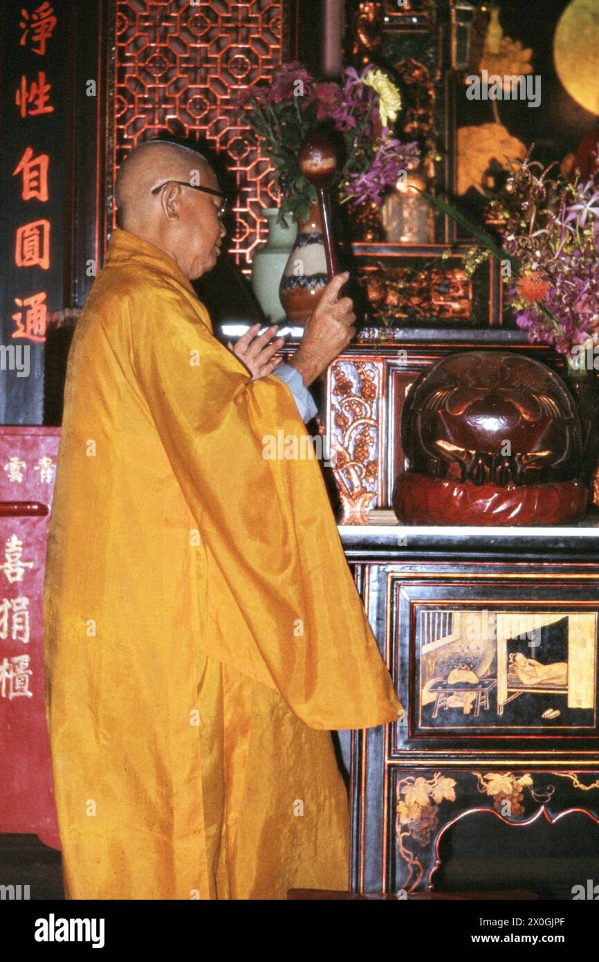 Praying monk during a service at the Cheng Hoon Teng Temple in Malacca ...
