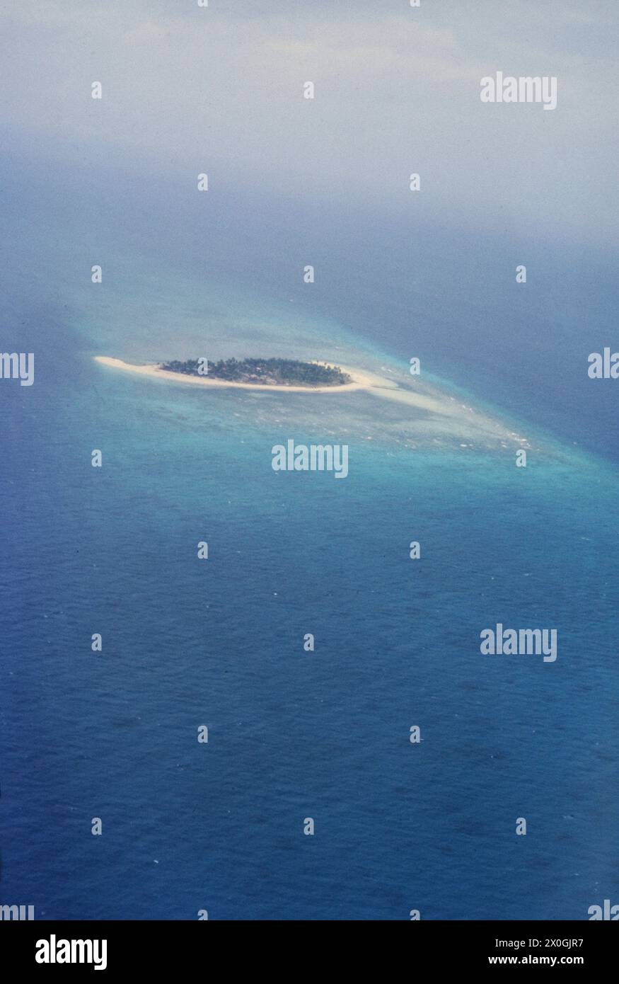 View from the airplane of a coral island in the Strait of Cebu ...
