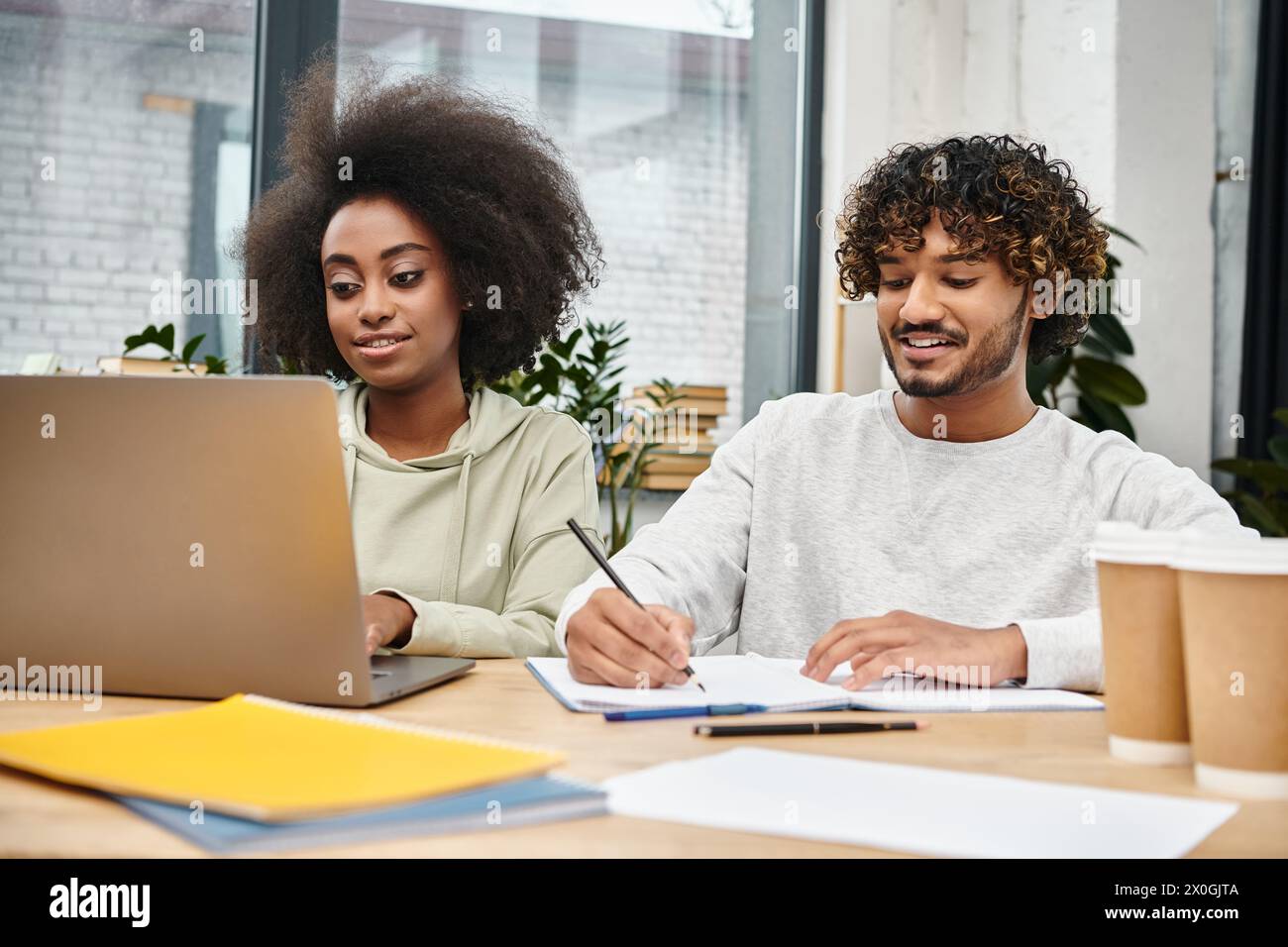 Multicultural students engage in collaborative studying with laptops in ...