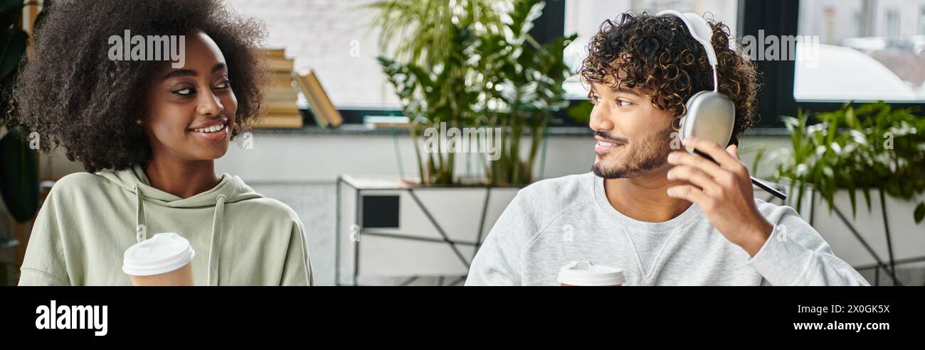 A man and woman, representing cultural diversity, chat while studying ...