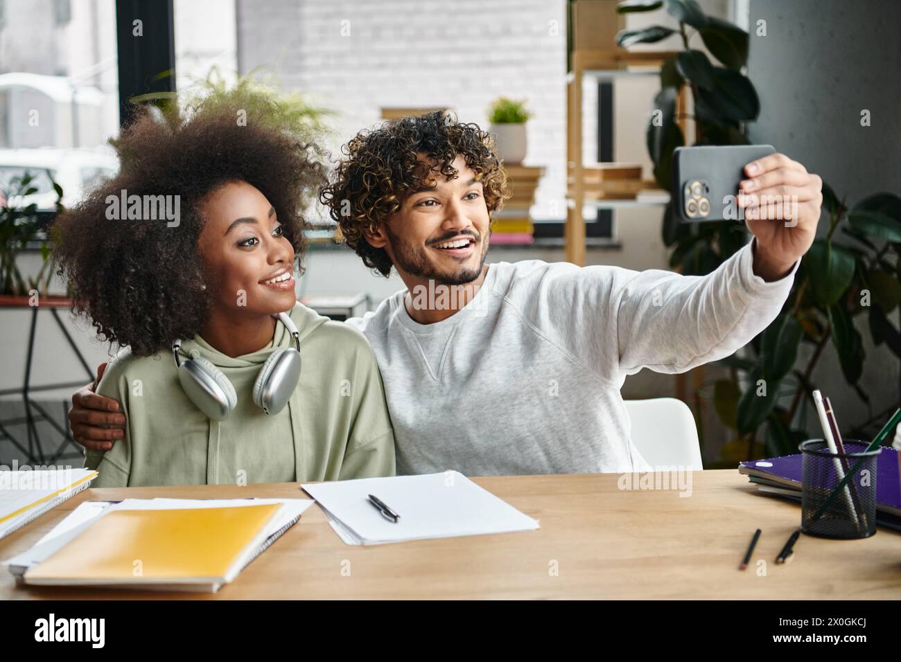 A man and woman capture a moment, smiling together while taking a ...