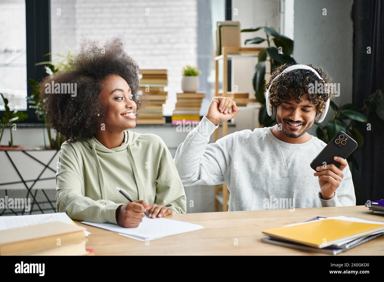 A man and a woman from different cultural backgrounds sit together at a ...