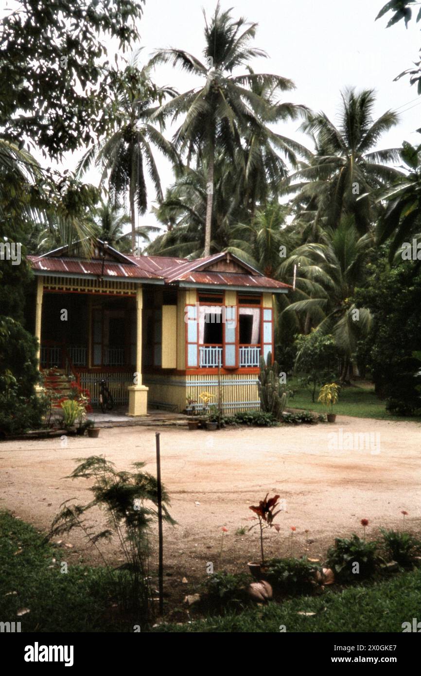 A typical Malaysian wooden house in a village near Muar. [automated ...
