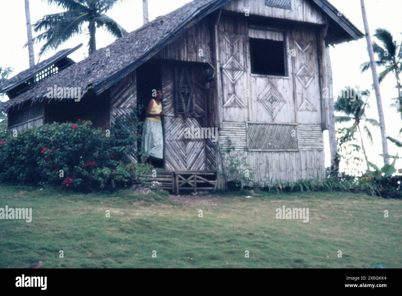 A woman stands in the entrance of a typical Bohol house in Bohol ...