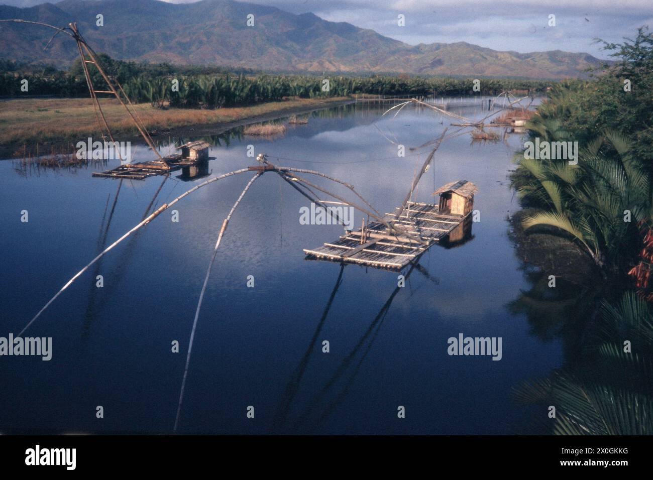 Fishing rafts on a river in the Philippines. [automated translation ...